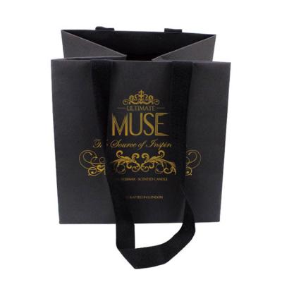 China Matt Black Kraft Paper Gift Bags Clothing Packaging Bags With Handles And String for sale