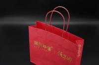 China recycled Eco Paper Bags Hot Stamping Red Kraft Bags With Handles Twisted for sale