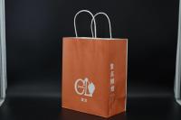 China Custom Orange Eco Paper Bags With Handles Twisted Solid Plate Printing for sale