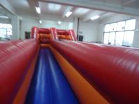 China Outdoor Inflatable Bungee Run Game for Two People Challenge Race Dual Lanes Interactive Inflatable Games for sale