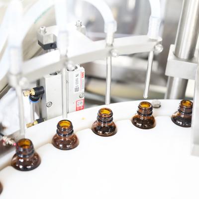 China 4 Nozzles Pharmaceutical Filling Machine Glass Dropper Bottle Filling Capping Machine for sale