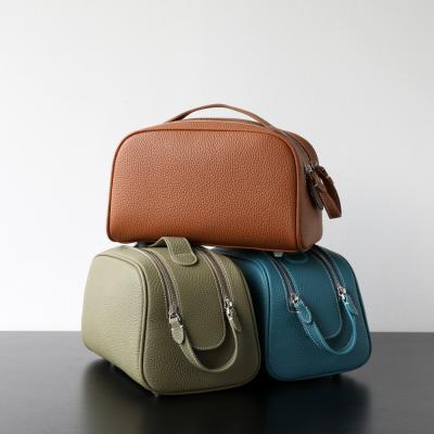 China 2026 New Lychee-Textured Vintage Colors PU Leather Cosmetic Bag Women's Portable Travel Toiletry Bag High-End Organizer for sale