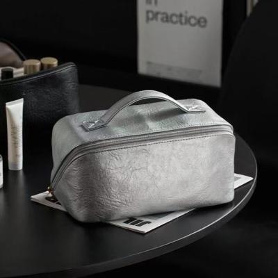 China Women's Large Capacity Portable Luxury Makeup Bags 2025 New Silver Waterproof Toiletry Travel Daily Organizer Cosmetic Pouch for sale