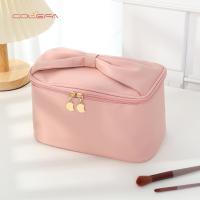 China PU Soft Leather New Arrival Travel Portable Makeup Bags Storage Large Capacity Waterproof Stylish Bow Handle Cosmetic Bag for sale
