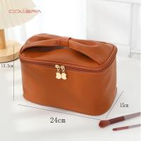China PU Soft Leather New Arrival Travel Portable Makeup Bags Storage Large Capacity Waterproof Stylish Bow Handle Cosmetic Bag for sale