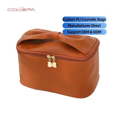 China PU Soft Leather New Arrival Travel Portable Makeup Bags Storage Large Capacity Waterproof Stylish Bow Handle Cosmetic Bag for sale