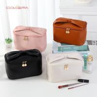China PU Soft Leather New Arrival Travel Portable Makeup Bags Storage Large Capacity Waterproof Stylish Bow Handle Cosmetic Bag for sale