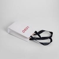 China Ribbon Handle Ivory Board Paper Bags With Custom Logo For Handmade Clothing Packaging for sale