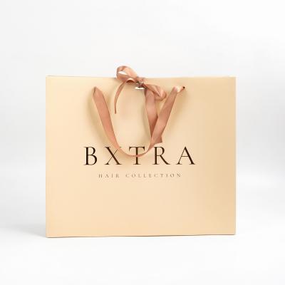 China Hand Length Handle Customized Logo Clothing Garment Peach Paper Bag with Ribbon for sale
