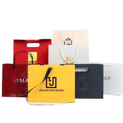 China Jewelry Gift Paper Shopping Bag with Custom Logo and Hand Length Handle Luxury Design for sale