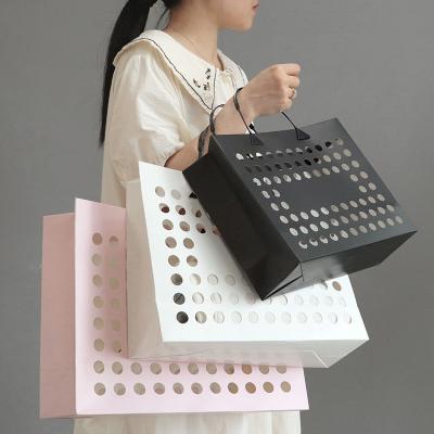 China Business Shopping Gravure Printing High End Fashion Luxury Heavy Hollow Out Paper Bags for sale