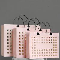 China Business Shopping Gravure Printing High End Fashion Luxury Heavy Hollow Out Paper Bags for sale
