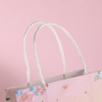 China Custom Boutique Pink Kraft Handle Paper Bags With Gravure Printing And Customized Logo for sale