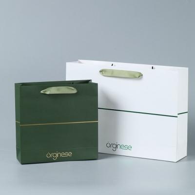 China Customized Logo Accepted Ivory Board Paper Bags for Boutique Requirement for sale