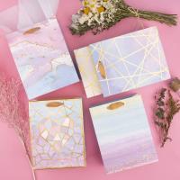 China Designer Folding Glossy Shopping Paper Bag With Ribbon Handle and Gravure Printing for sale