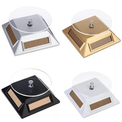 China 360 Degree Rotating Solar Display Stand with LED Light - 10x10x4.5cm for Mobile Phones Jewelry Watches for sale