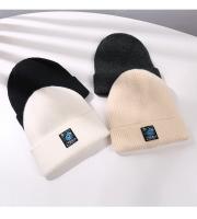 China Knitted Winter Hat Made From Recycled PET Bottles With Woven Patch And Custom Design for sale