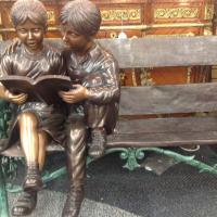 China Metal Life Size Bronze Kids Children Sculpture Girls Lying And Reading Statue for Decor for sale