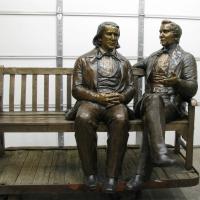 China Custom Life Size Outdoor Modern Garden Bronze Man Sculpture Sitting On Bench For Sale for sale