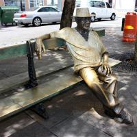 China Sitting On Park Bench Embracing Life Size Bronze Couple Statue Man And Woman Sculpture For Sale for sale