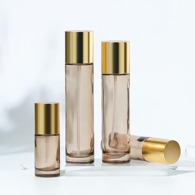 China High-quality transparent glass cosmetic bottle with gradient paint and customized logo for lotion packaging for sale
