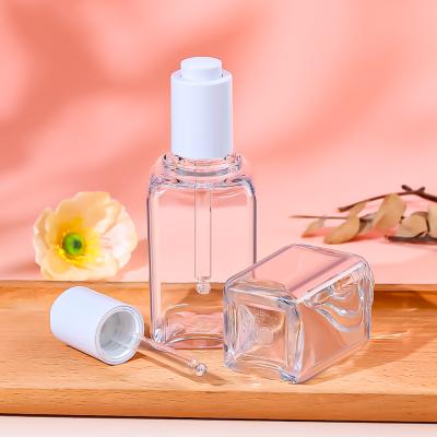 China Transparent PETG Dropper Bottle with Thick Wall and Customizable Push Button for Skincare Packaging for sale