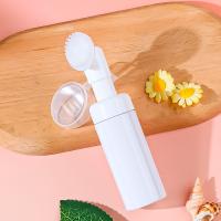 China 100ml Foam Pump Bottle with Silicone Brush for Refillable Facial Cleanser Packaging for sale