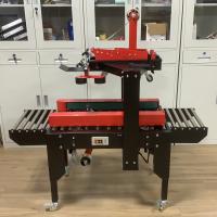 China Electric Driven Semi Automatic Case Carton Box Taping Sealer with Sole Universal Wheel for sale
