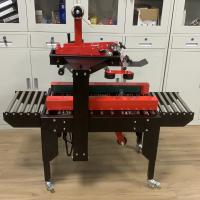 China Electric Driven Semi Automatic Case Carton Box Taping Sealer with Sole Universal Wheel for sale