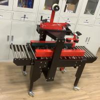 China Electric Driven Semi Automatic Case Carton Box Taping Sealer with Sole Universal Wheel for sale