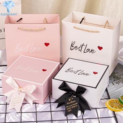 China Luxury Wine Cosmetics Glossy Varnish Pink Magnetic Gift Box With Ribbon for sale