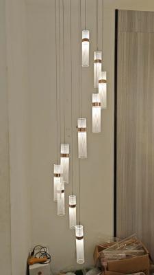 China Duplex Long Chandelier Staircase Fashion Light Luxury Simple Postmodern Creative Rotating Loft Art Hollow Living Room Light for sale