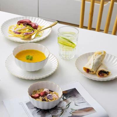 China Ceramic tableware bone dinnerware crafted from natural materials with bright glaze and unique scalloped wave edge design for sale