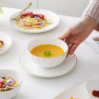 China Ceramic tableware bone dinnerware crafted from natural materials with bright glaze and unique scalloped wave edge design for sale