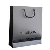 China Custom Printed White Paper Gift Bags Wholesale Spot UV Logo Ribbon Handle for sale