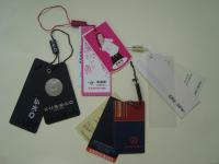 China Printed Paper Hang Tags For Clothing Line Plastic Seal Tag UV Coating Silver Foil Logo for sale