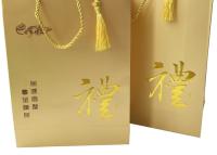 China Custom Luxury Printed Gold Paper Gift Bags With Embossed Logo Tassel Handles for sale