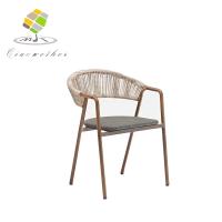 China Aluminum Tube Frame Garden Outdoor Stackable Arm Chair Weather Resistant Rattan Chair for Cafe Restaurant for sale
