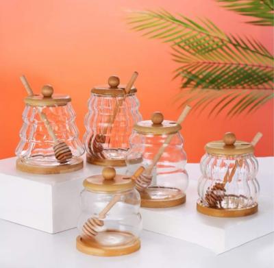 China OEM Striped High Borosilicate Glass Storage Jar 330ml 450ml Honey Pot with Stirrer Lid for sale