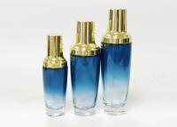 China Glass Reusable Lotion Bottles 60ml-150ml with Press Pump - Customizable Blue Spraying & Gold Cap Packaging for sale