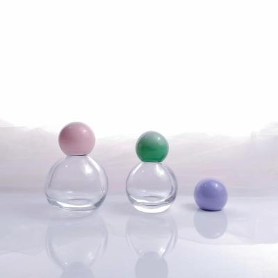 China Refillable Bulk Perfume Bottles 30ml 50ml Transparent Glass with Lid Sealing and Custom Logo Options for sale