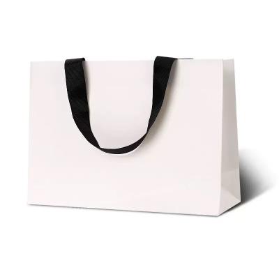 China 20cm x 15cm White Intaglio Printed Paper Carrier Bags with Zipper Top and Black Ribbon Handles for sale