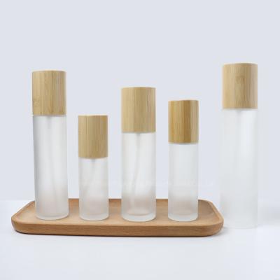 China Custom Logo Attar Atomizer Spray Bottle 60ml 100ml Plastic with Wooden Cap for Cosmetics and Personal Care for sale