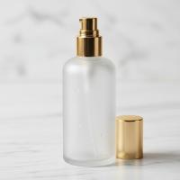 China Empty Lotion Bottle Luxury 1oz Glass Frosted with Gold Pump 60ml 100ml for sale