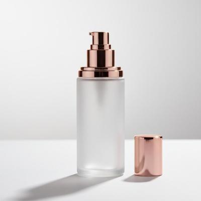China Empty Lotion Bottle Luxury 1oz Glass Frosted with Gold Pump 60ml 100ml for sale