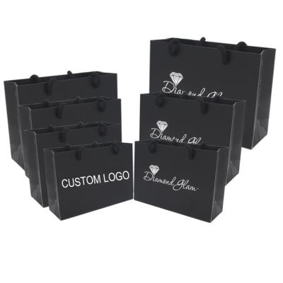 China manufacture custom reusable retail luxury logo Printed cardboard paper bags white logo boutique shopping paper gift carry bags for sale