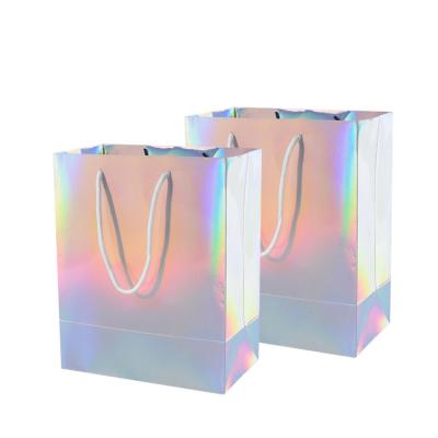 China Luxury Custom Logo Printing Large Advertising Glitter Hologram Silver Foil Logo White Gift Carrier Laser Paper Bag for sale
