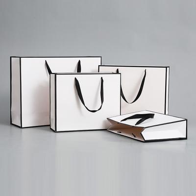 China Paper Bag Custom Printed Logo Luxury Clothing Shopping Paper Bags Boutique Recyclable Gift Bag With Ribbon Rope for sale