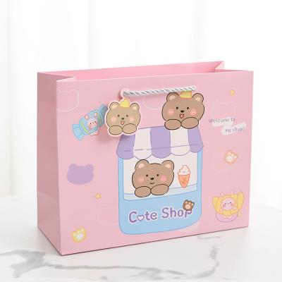 China Christmas Gift Free Luxury Clothes Package Ribbon Bow Cardboard Customized Paper Bag for sale