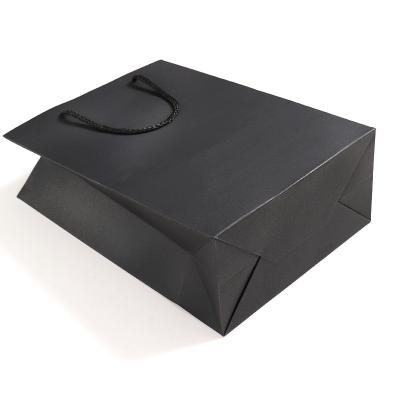 China Custom Printed Cardboard Luxury White Kraft Paper Gift Bag With Ribbon Handle For Shopping With Your Own Logo for sale